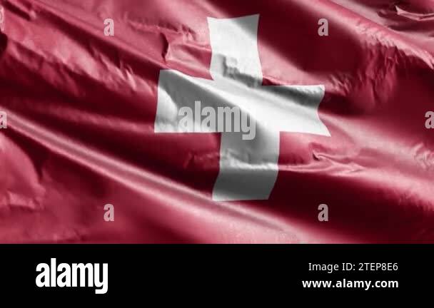 Switzerland textile flag slow waving on the wind loop. Swiss banner ...