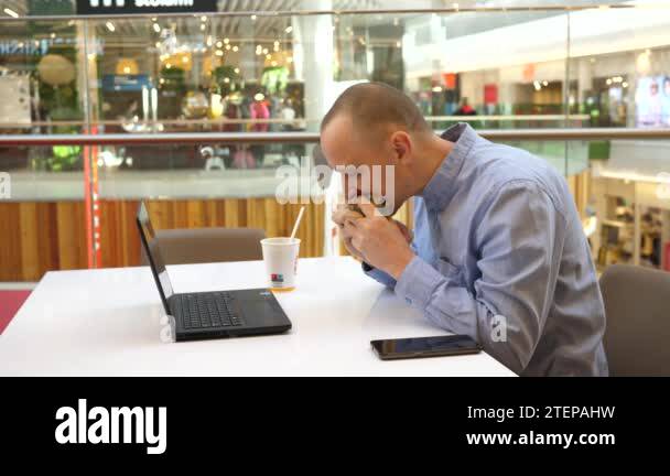 WROCLAW, POLAND - FEB 03, 2022: Young man working remotely from a city ...