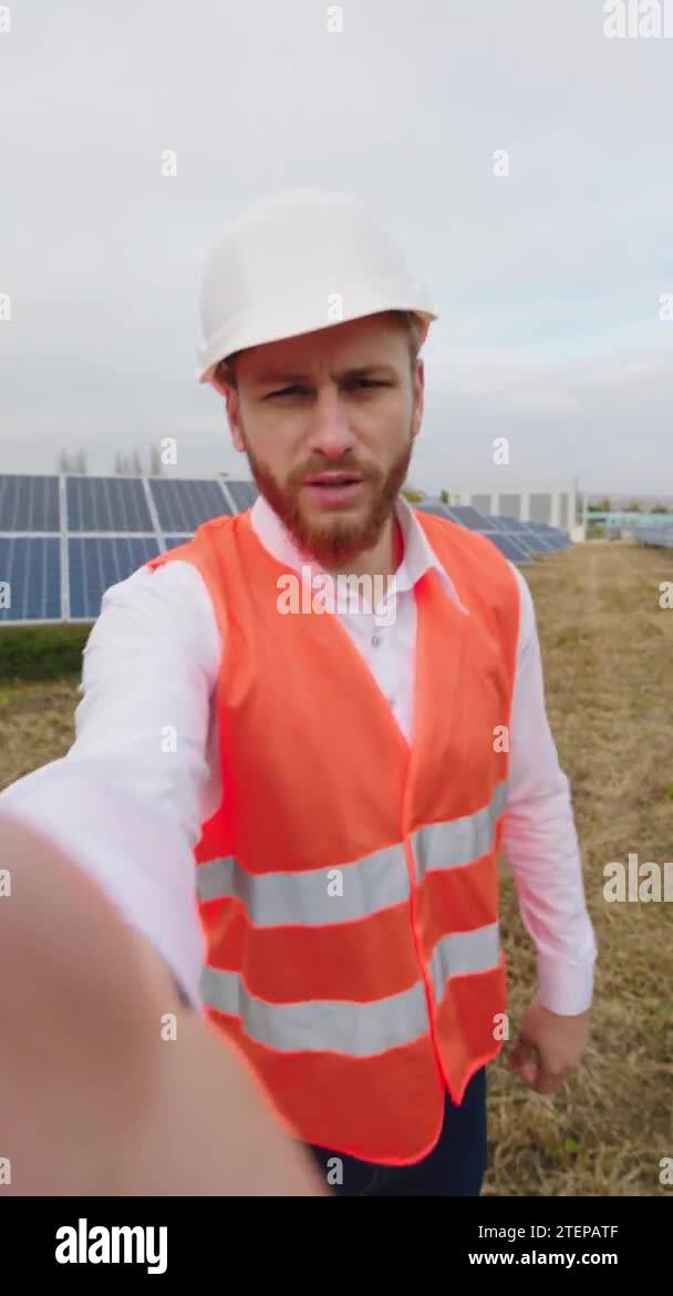 Charismatic ecological engineer at solar power station using camera to ...