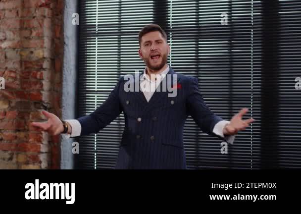 Portrait: excited successful handsome smart guy in an expensive suit is ...