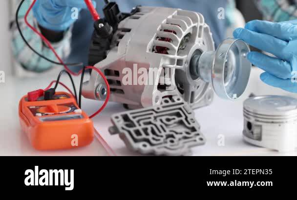 Mechanical engineer diagnosing breakdown of car alternator using tester ...