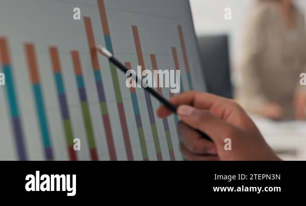 Close-up of computer monitor bar graph displayed dark-skinned mans hand ...