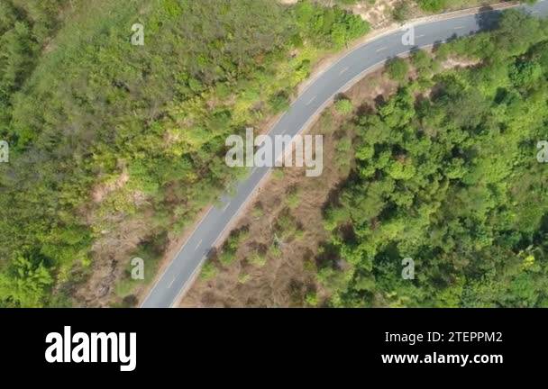 Aerial view Top down view of curves of road.Highway and freeway road Cinematic drone shot flying ...