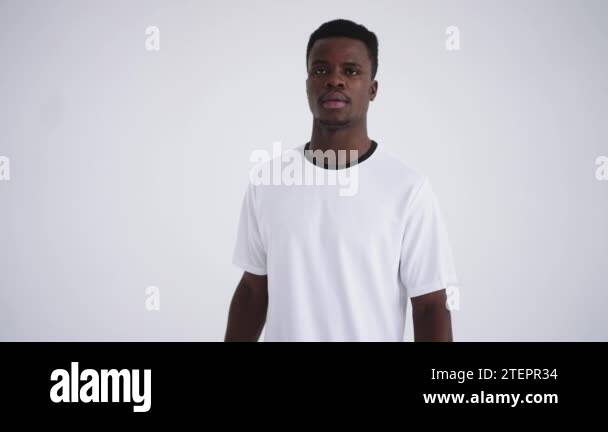 Portrait of an African ethnic footballer in a white uniform on a white ...