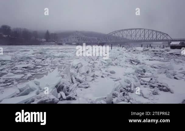 Drone flying low over big ice chunks on a snowy river in Connecticut ...