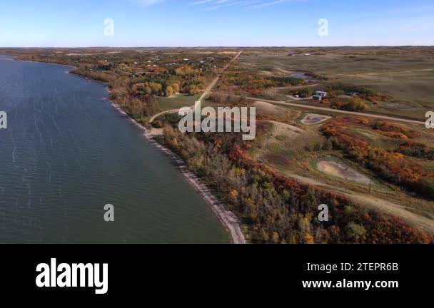 Aerial orbiting camera movement high above buffalo lake near Rochon ...