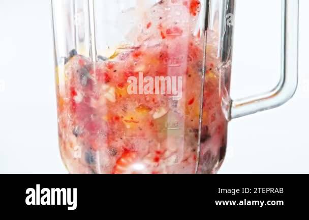 Super slow motion of mixing pieces of fruits in blender. Filmed on high ...