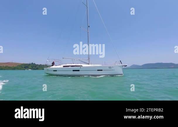 Sailing boat monohull without sails goes on the waves, sailing yacht ...