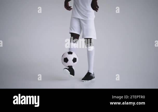 A professional black football player in a white uniform on a white ...