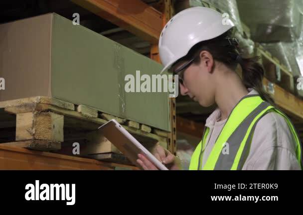 Controller girl in safety helmet and vest during factory inspection ...
