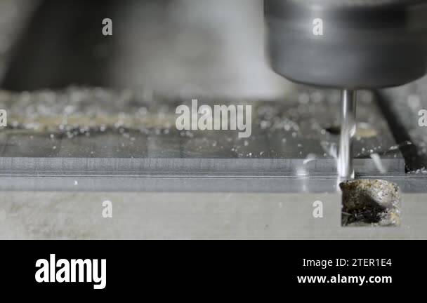 Twisted pieces of excess metal fly off a piece of aluminium during ...