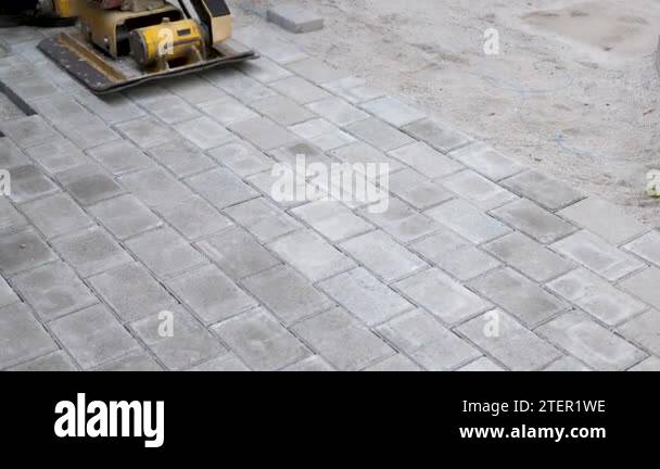 Machine for compaction, vibrating plates on paving stones. The concept ...