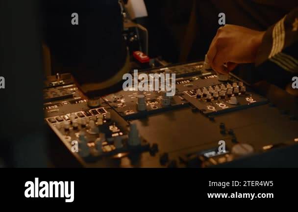 Captain and copilot pushing dashboard buttons to start engine, using ...