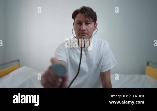 Patients POV of focused professional doctor listening auscultation with ...