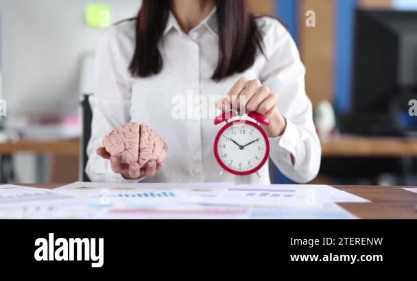 Woman holds out alarm clock and model of human brain Stock Video ...