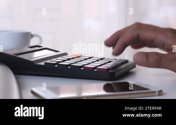 4K man hand using calculator on office desk. Male hand press calculator ...
