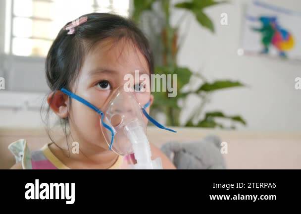 Kid girl making makes inhalation nebulizer steam sick cough at home ...