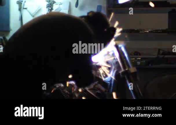 Automaster weld the frame of a custom motorcycle in the garage Stock ...