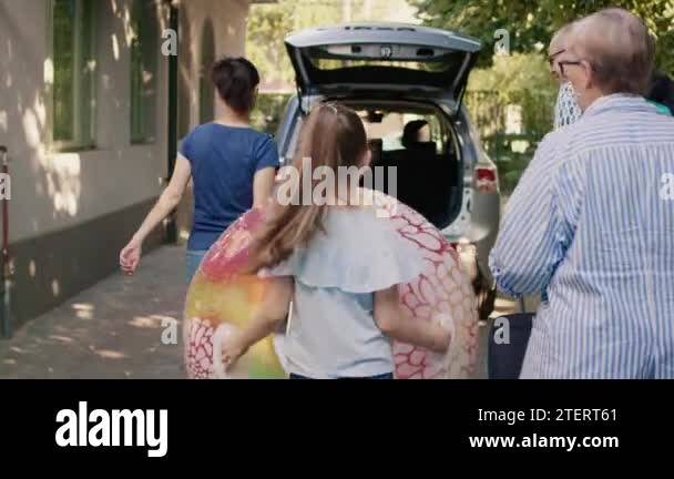 Family loading voyage luggage in car trunk while getting ready for ...