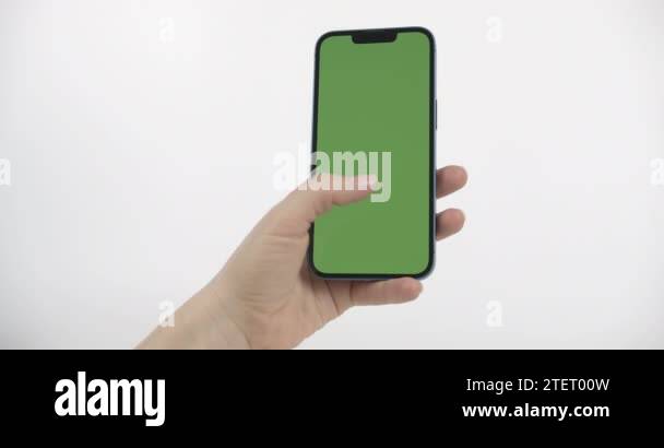 Woman Holds Smartphone with Green Screen Vertically and Swipes Pictures ...