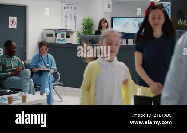 Busy hospital reception desk with many patients waiting to start ...
