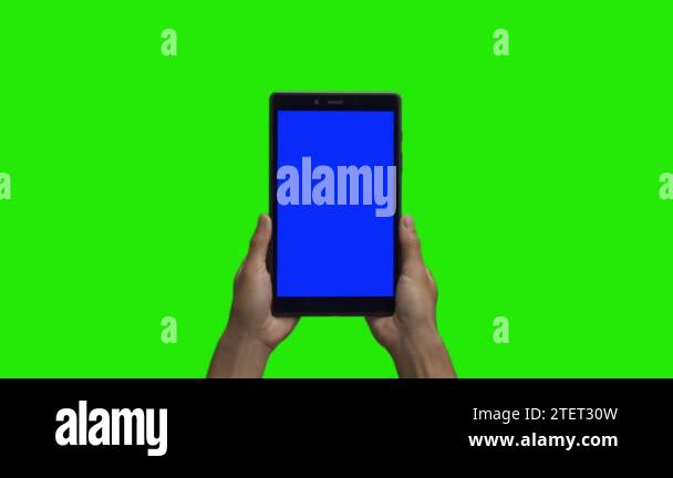 Tablet in the hand close up isolated at green background. Tablet screen ...