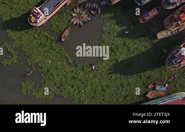 Top down aerial river side ship wrecking dockyard with slum buildings rooftop at Dhaka ...