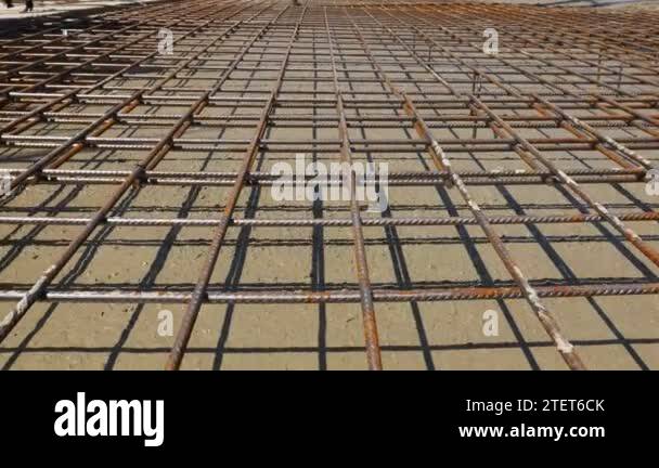 Low angle view, perspective, on flow fresh liquid concrete is slowly ...