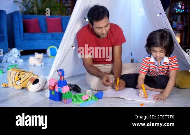 Sweet adorable boy with long hair and his young dad drawing a sketch ...