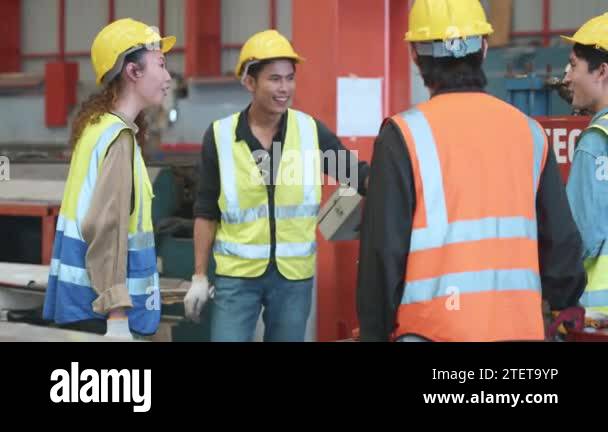 Break time. Happy engineer team talking together in roof steel metal ...