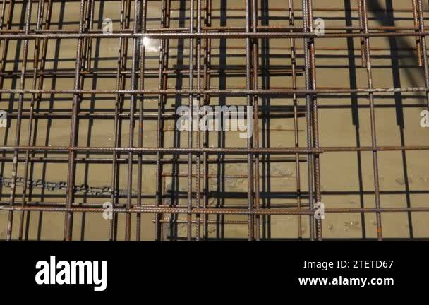 Concrete is spreading in foundation under reinforcing steel bars. Fresh ...