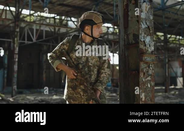 Armed man in US military uniform and helmet stand guard while defending ...