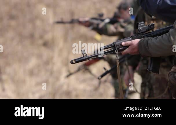 A machine gun is being used by a men on a shooting range in order to ...