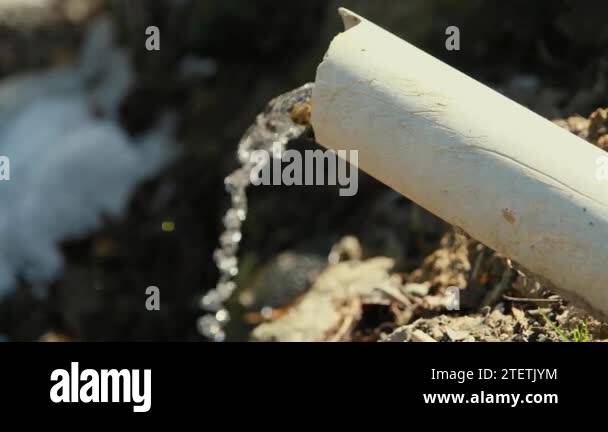 4k video of flowing water, clean and drinkable water with snow ...