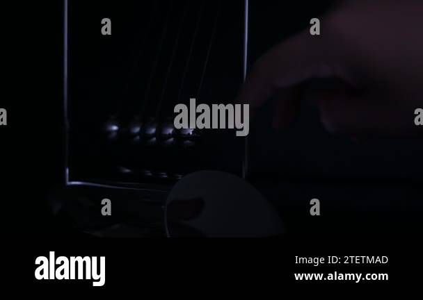 Hand putting a newtons cradle balancing balls in dark tone. movement ...