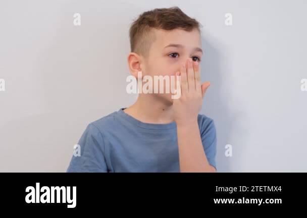 Bad breath. Halitosis concept. Child checking his breath with his hand ...