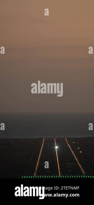 Vertical video - frontal view - a passenger propeller airplane picks up ...