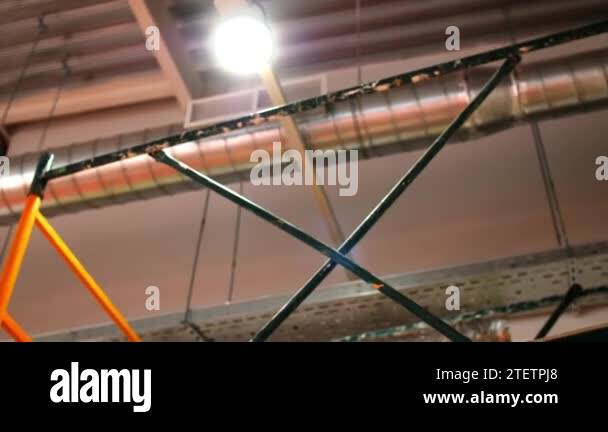 Dirty scaffolds in room with lightbulb and ventilation pipe Stock Video ...