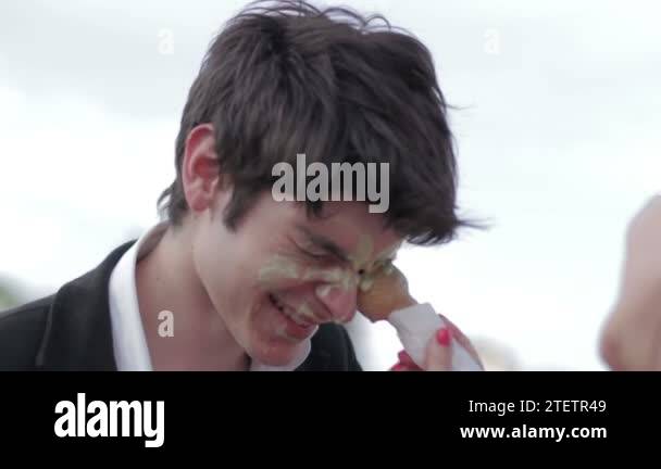 bad joke - girl spreads ice cream cone in the face of a boy - laughing ...