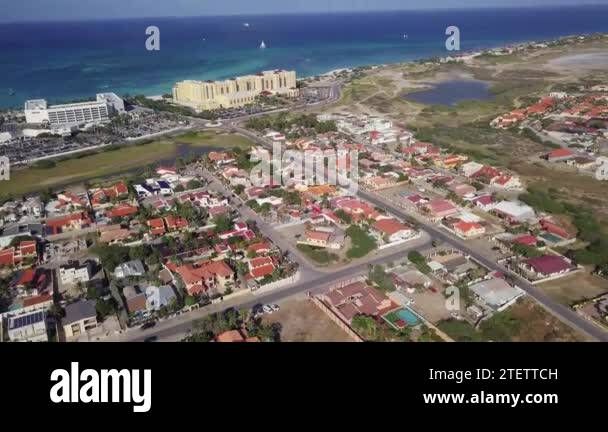 Pan and tilt up from a residential neighbourhood in Aruba to the North ...