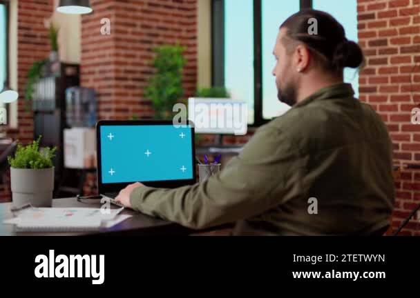 Startup employee analyzing business charts and greenscreen on laptop at ...