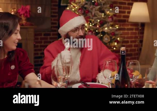 Funny husband disguised as Santa Claus discussing with people while ...