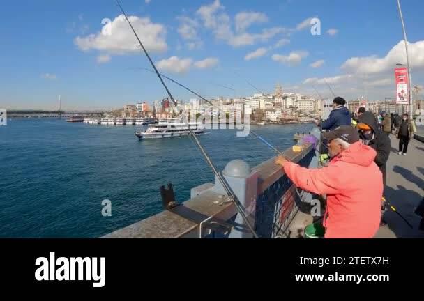 Fishermen fish from the Galata bridge. Slaves fish from a bridge in ...