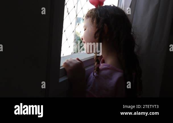 Little girl child looking outside through window, Small kid leaning on ...