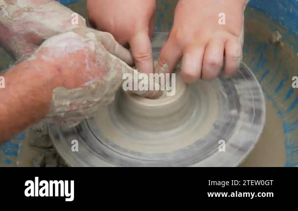 Clay modeling master class. Teacher show children hands clay pot ...
