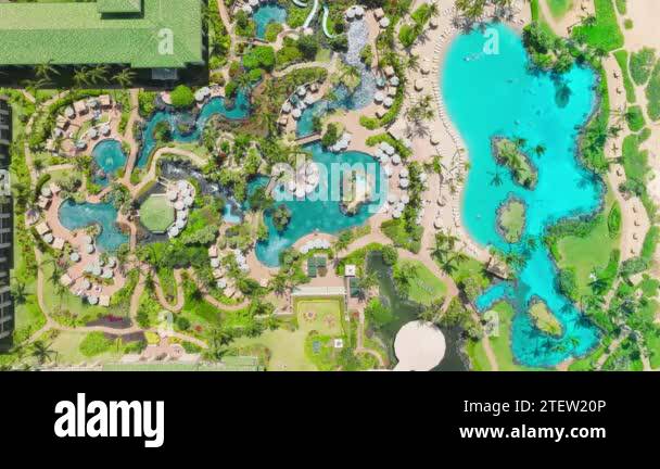 People swimming in scenic blue pools and lagoons enjoying luxury ...