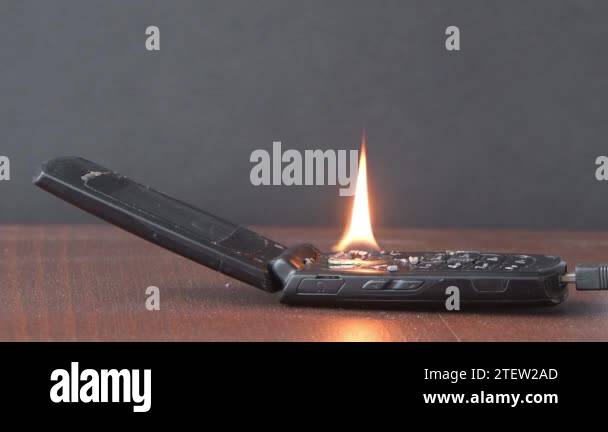 Old mobile phone fire, sparks and flames, battery oxidation. The cause ...
