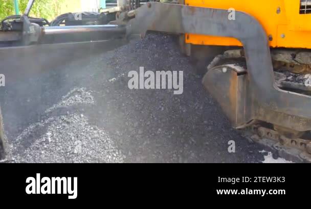 asphalt road with a lot of construction machinery, the process of lay ...