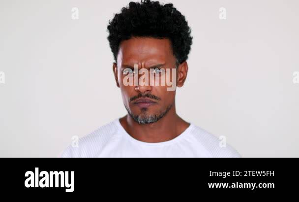 Suspicious black African man reaction to camera. Portrait guy reacting ...