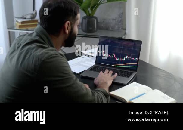 Trading online. Successful indian or arabian trader working with laptop ...